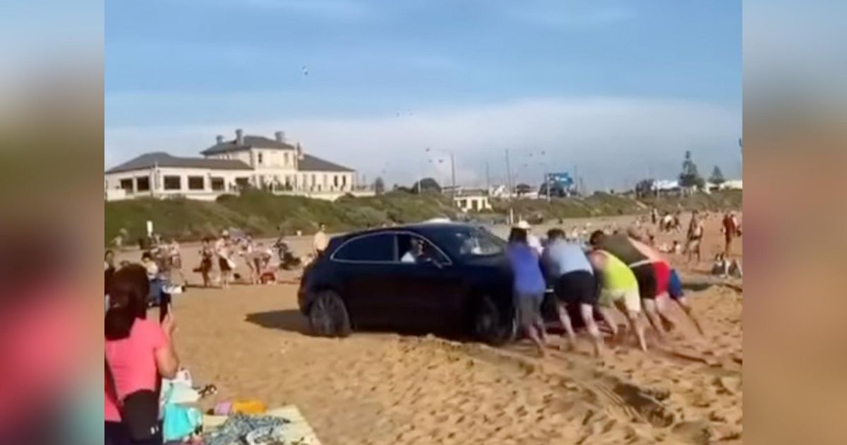 Porsche pandemonium on busy beach as luxury SUV gets bogged | CarExpert