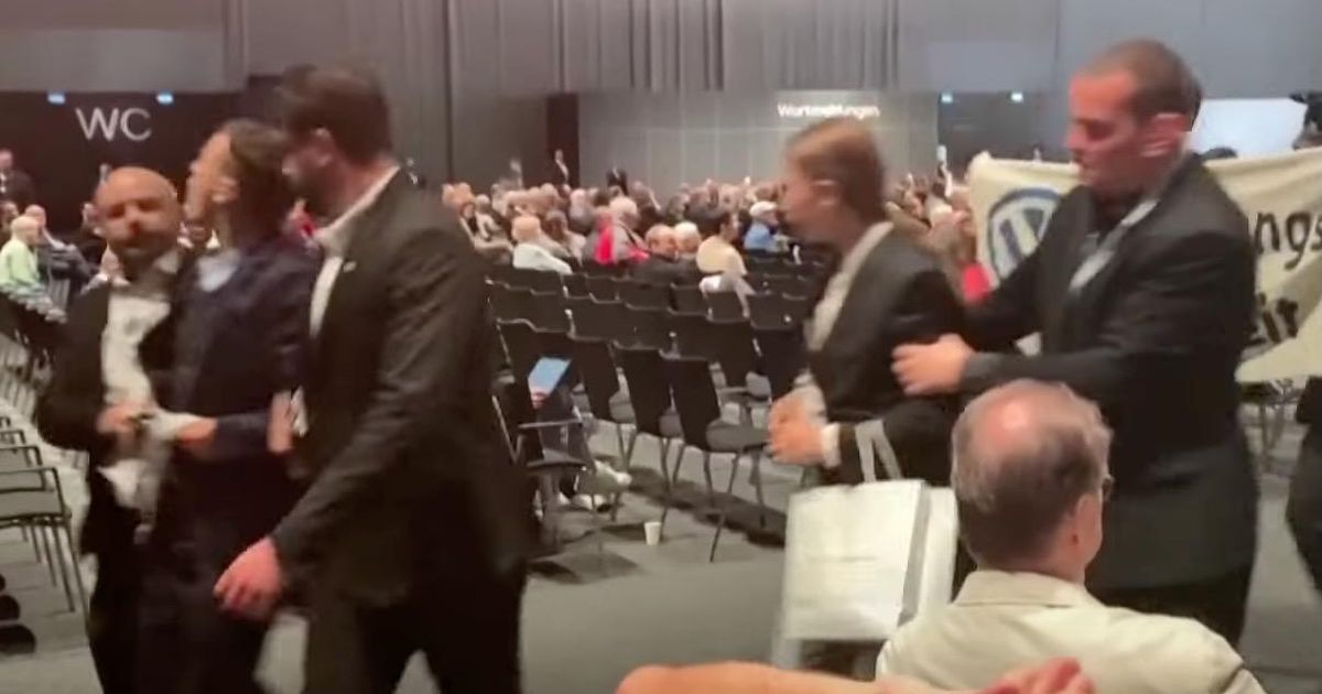 Cake flies as climate, human rights protesters take over VW event ...