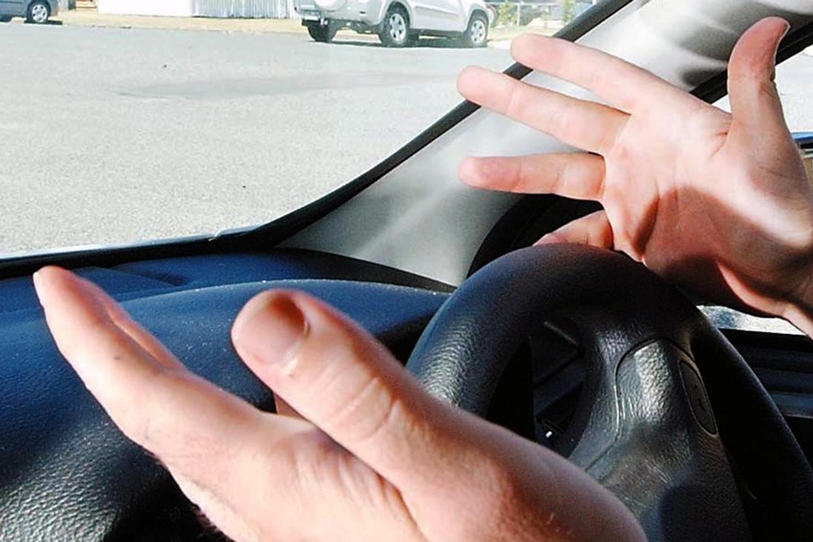Is it legal to drive with one hand? | CarExpert