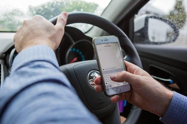 Is it illegal to use a mobile phone while driving? | CarExpert