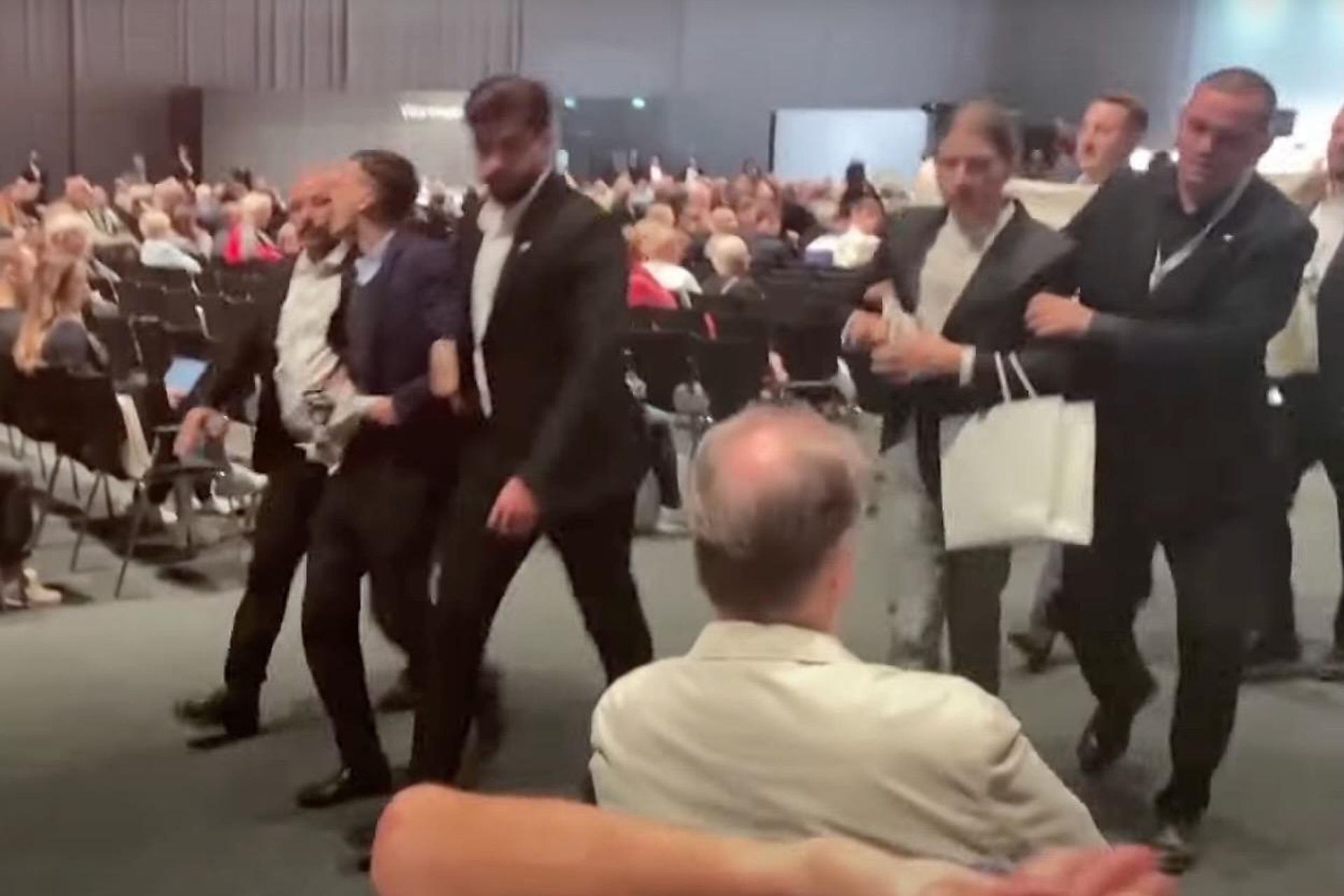 Cake flies as climate, human rights protesters take over VW event ...